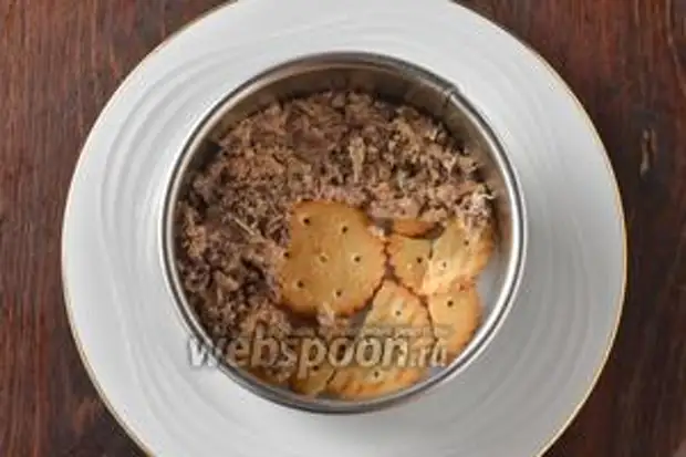 Kolektahin ang salad, alternating tulad ng mga layer (maaari kang gumamit ng pastry ring para dito): crackers, isda.