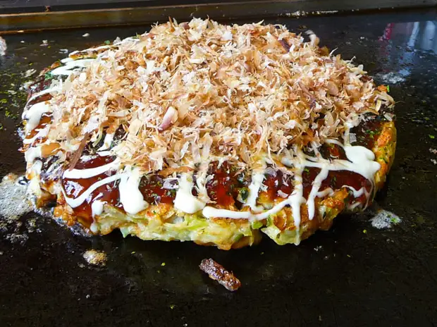 Окономіяки - одна з найпопулярніших страв японської вуличної кухні. Це — смажений коржик із суміші різноманітних інгредієнтів, змащений спеціальним соусом і посипаний дуже тонко нарізаним сушеним тунцем їжа, японія